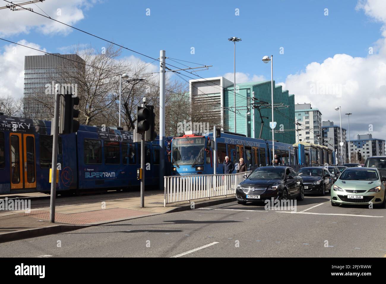 Sheffield Supertrams alongside road vehicles, Sheffield city centre ...