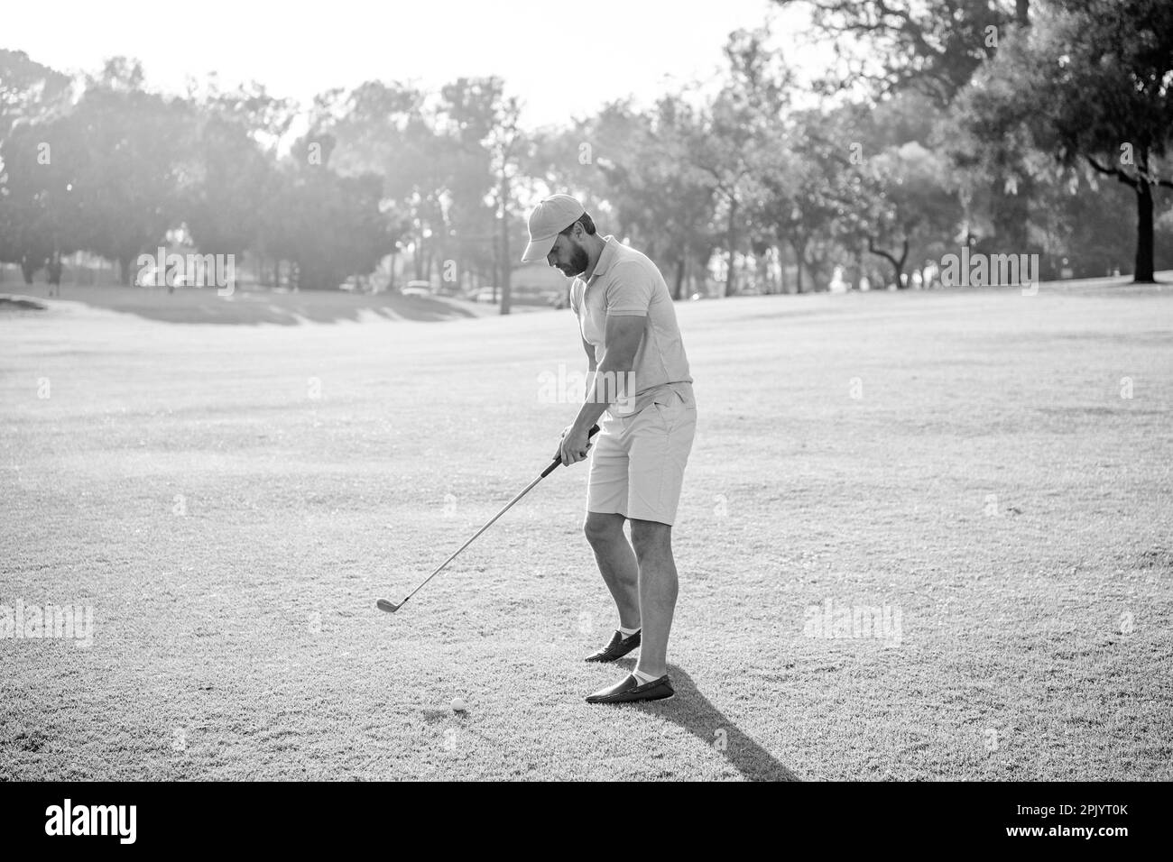 male golf player on professional golf course. portrait of golfer in cap ...