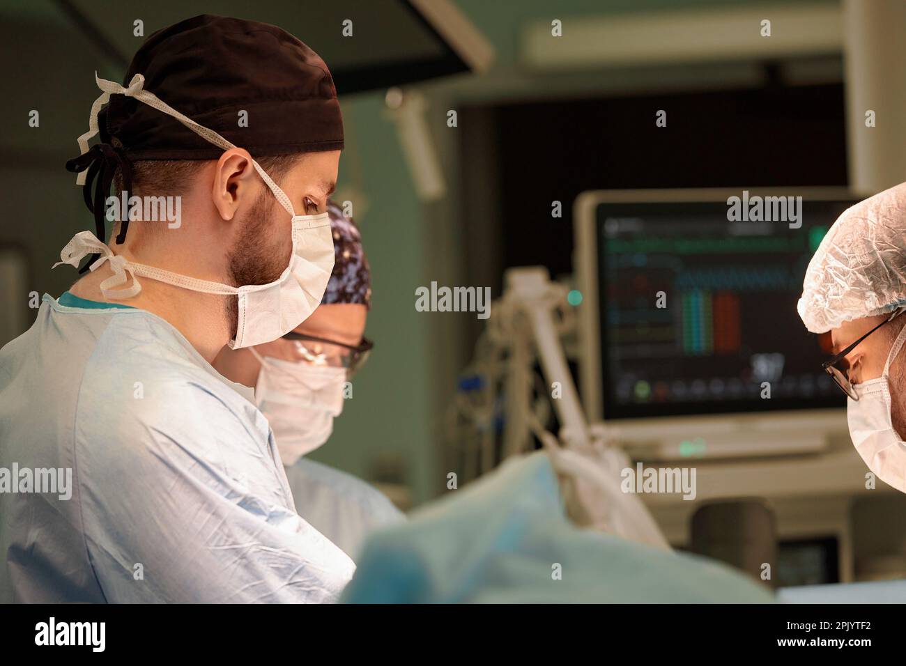 Shot of two experienced surgeons and an alert nurse performing an ...