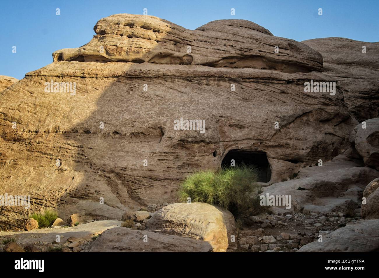 One of many historic hand carved caves in the valley of Petra. Jordan ...