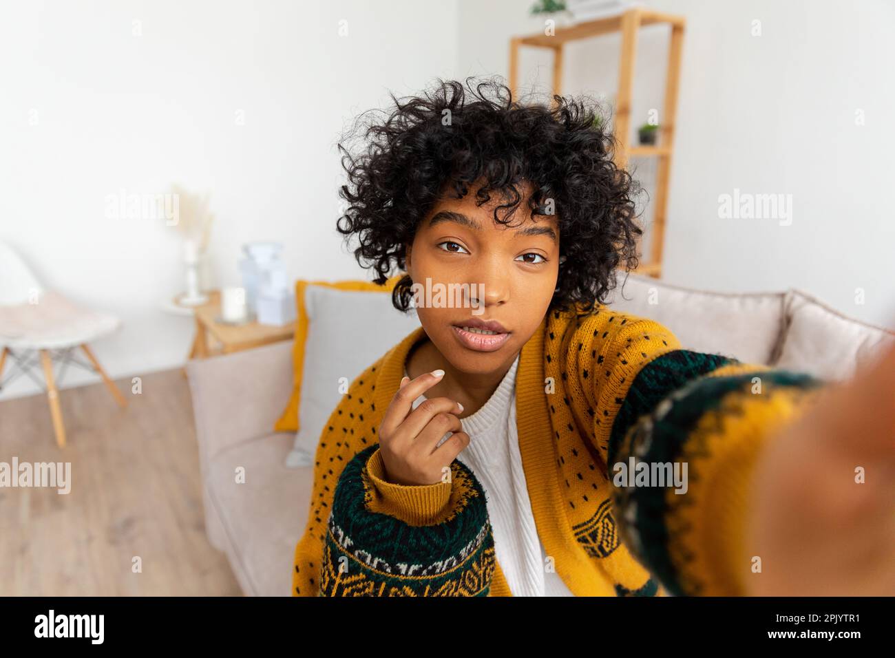Happy african american teen girl blogger smiling face talking to webcam ...
