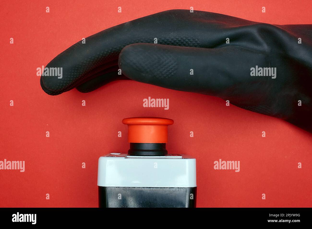 The hand in black resin glove, which is ready to push the emergency ...