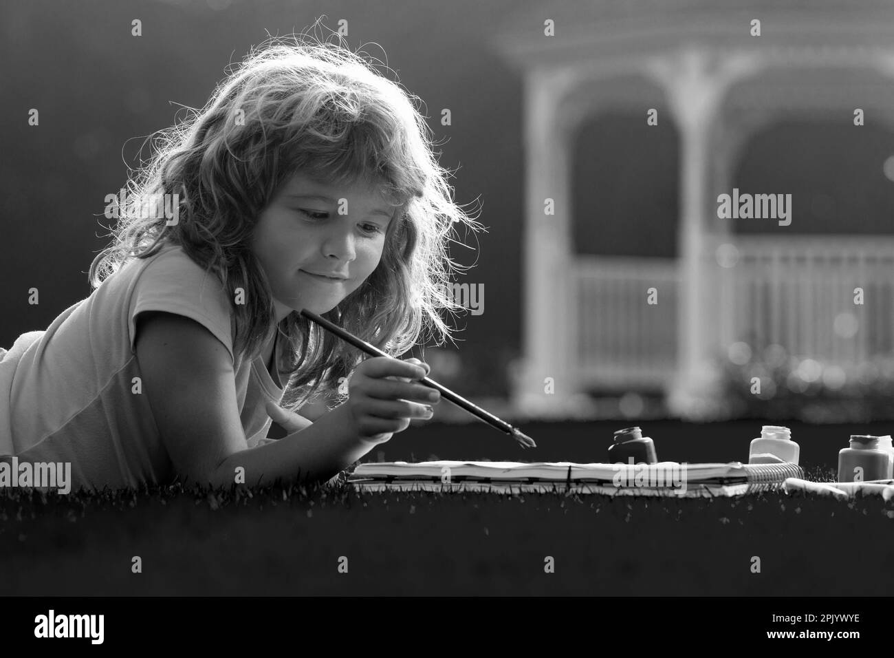 Portrait of smiling happy kid enjoying art and craft drawing in ...