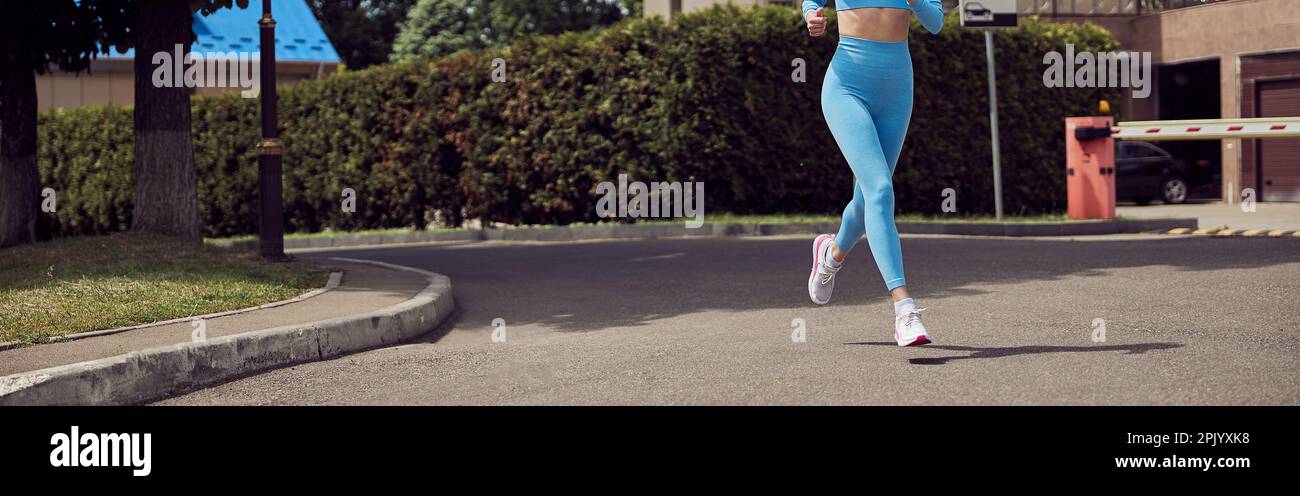 Beautiful fit young woman jogger is running outdoors Stock Photo - Alamy