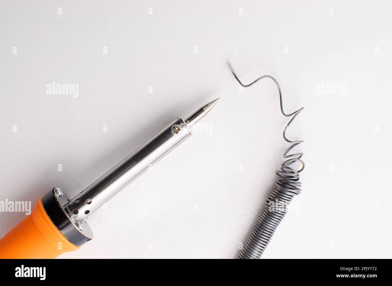 An electric soldering iron with wire on the side isolated on white ...