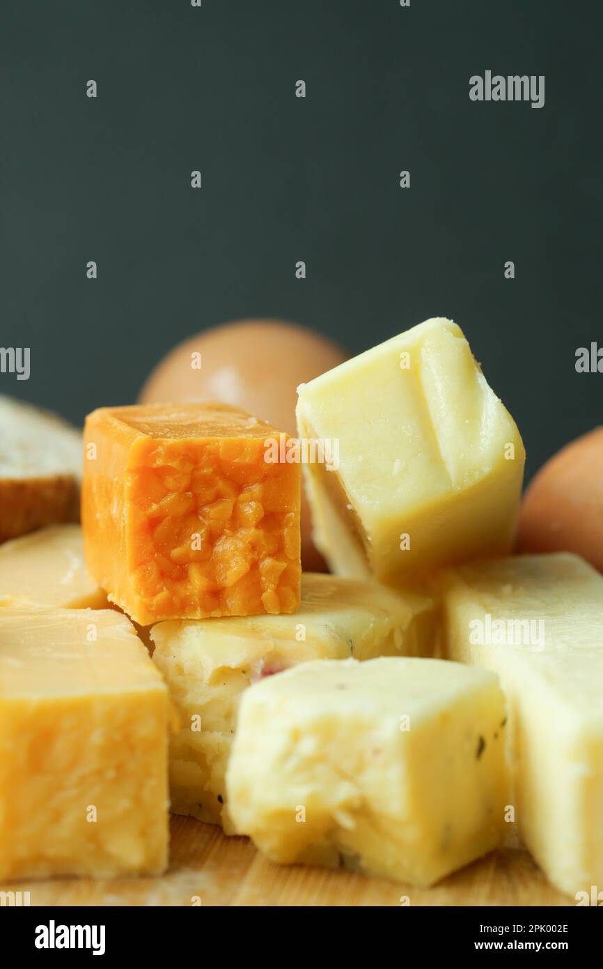 Cheese cubes green, yellow and red color on chopping board Stock Photo ...