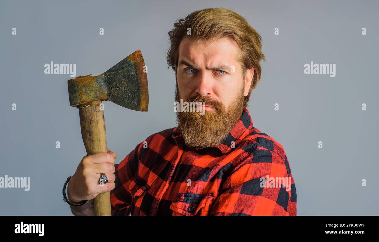 Serious bearded man with axe. Man in checkered shirt with old ax ...