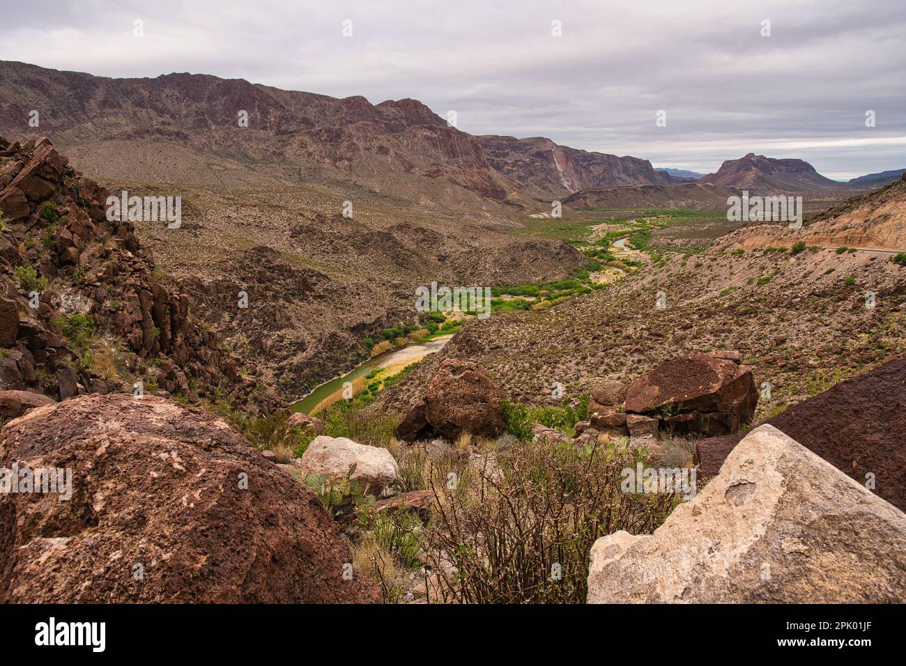 An arid desert landscape featuring a winding pathway meandering across ...