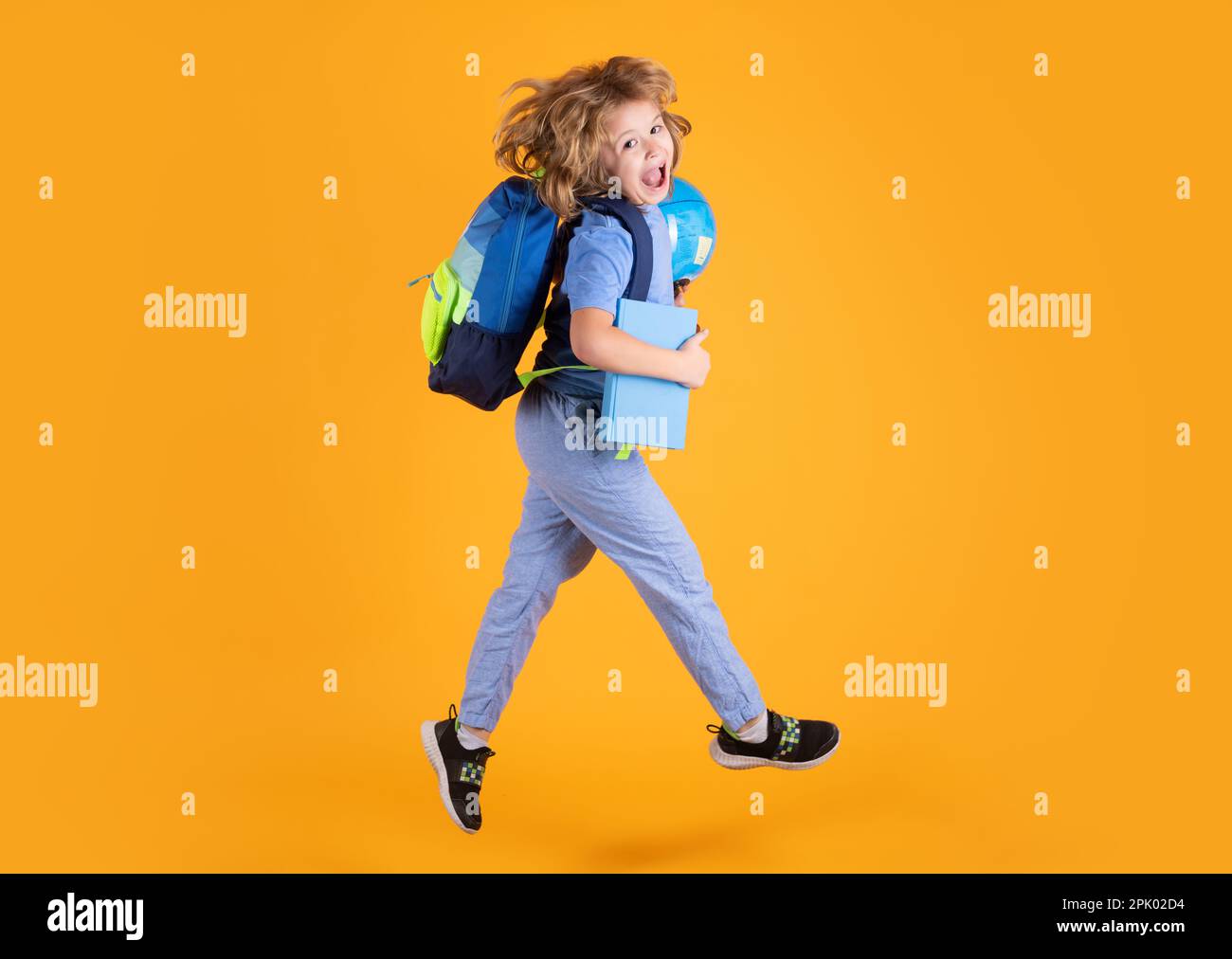 Kid jump and enjoy school. Full length body of cheerful school child ...