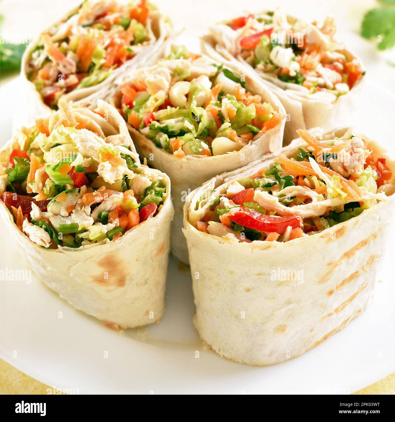 Close up view of tortilla wraps with chicken and fresh vegetables on ...