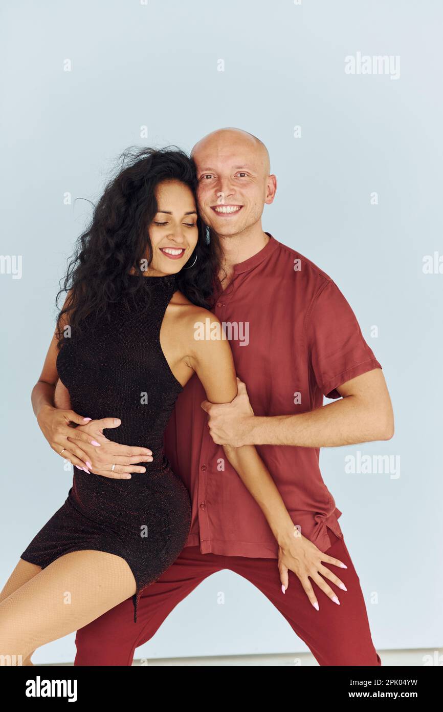Standing in the studio against white background. Cheerful couple is ...