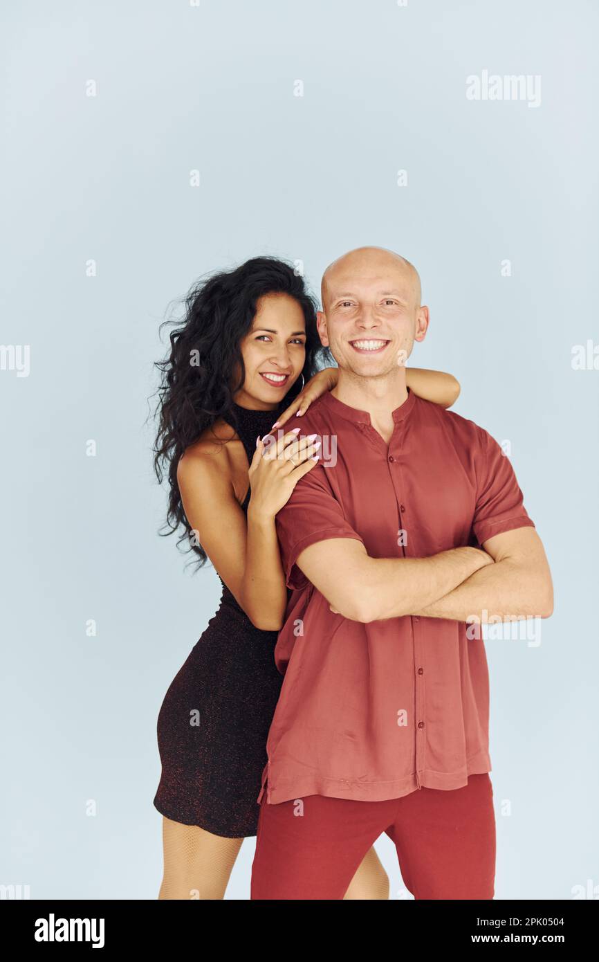 Standing in the studio against white background. Cheerful couple is ...