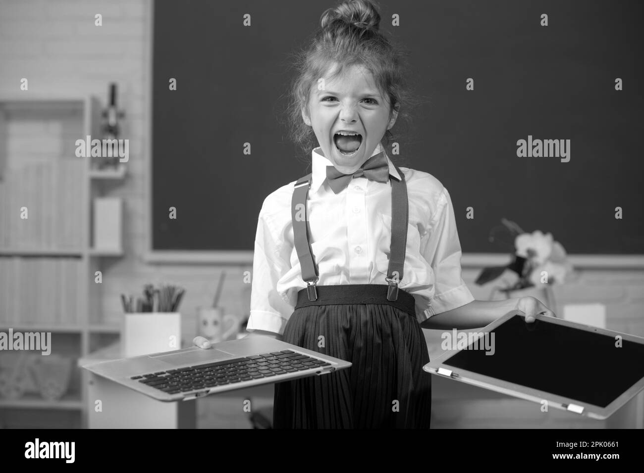 Angry girl in opposition distance education. School kid broken online ...