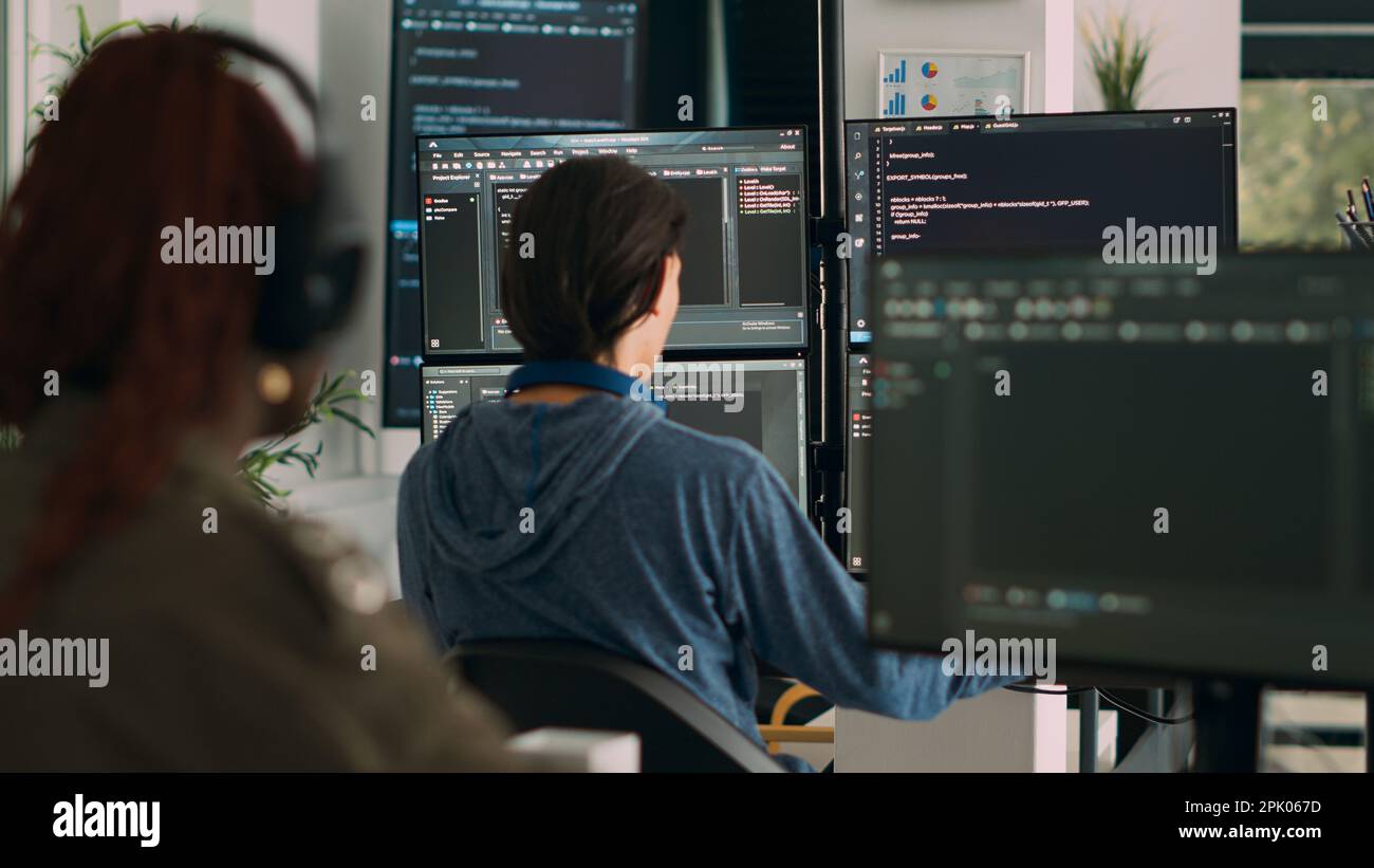 Database Programer Writing Code On Terminal Window Using Multiple Monitors In It Agency Office