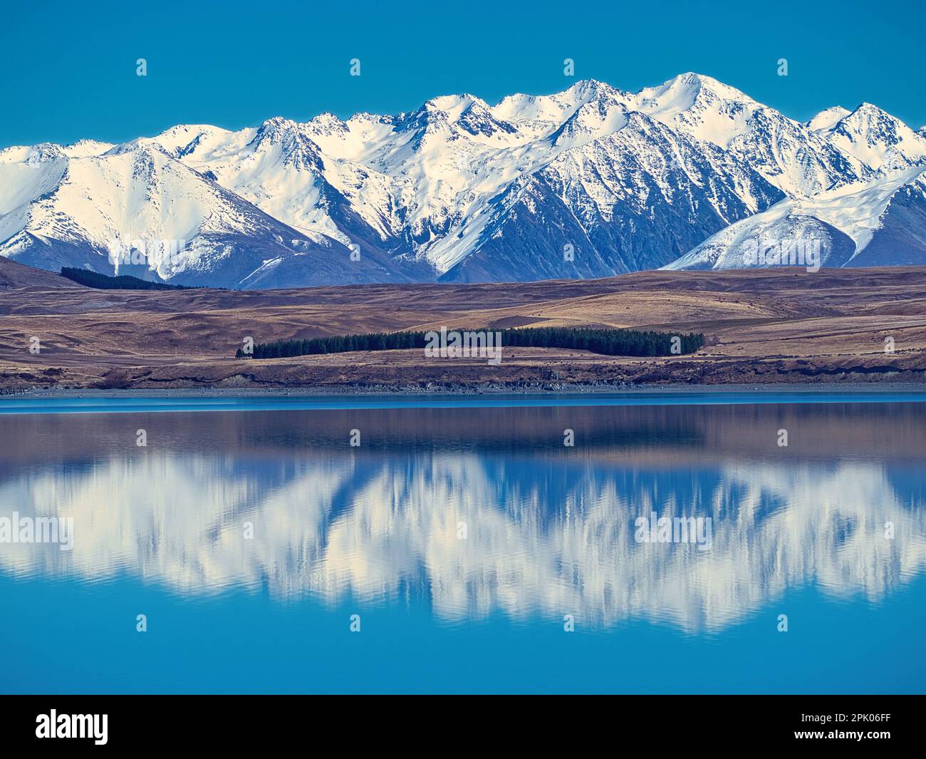 Reflection of pine trees in a lake and mountain landscape Stock Photo ...