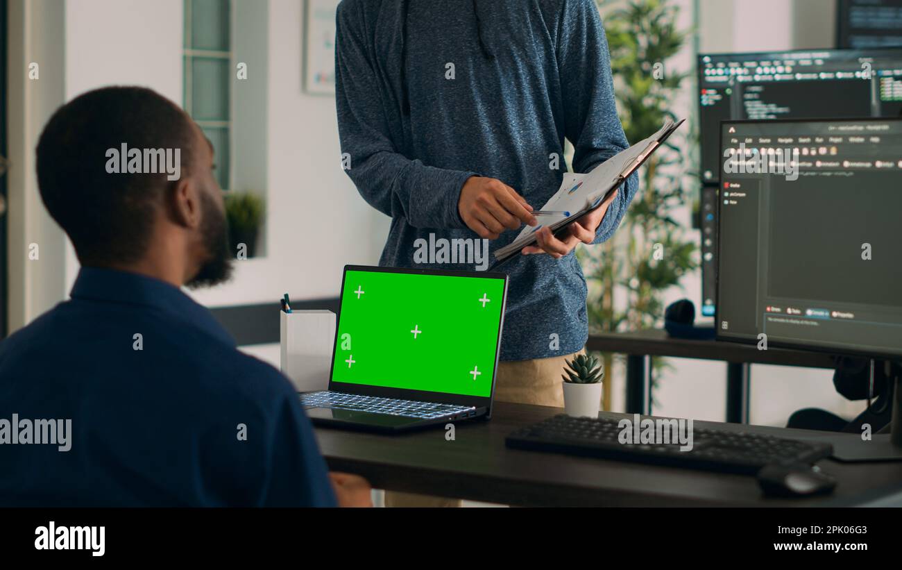 Diverse coders working on code developing and using greenscreen in IT agency office, programming ...