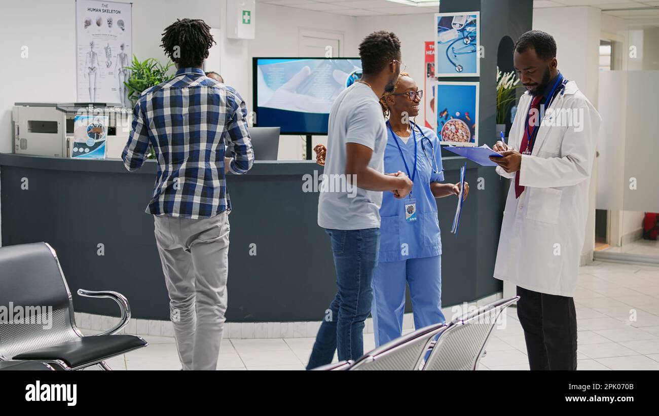 Medical workers talking to patient about consultation appointment, nurse asking doctor about ...