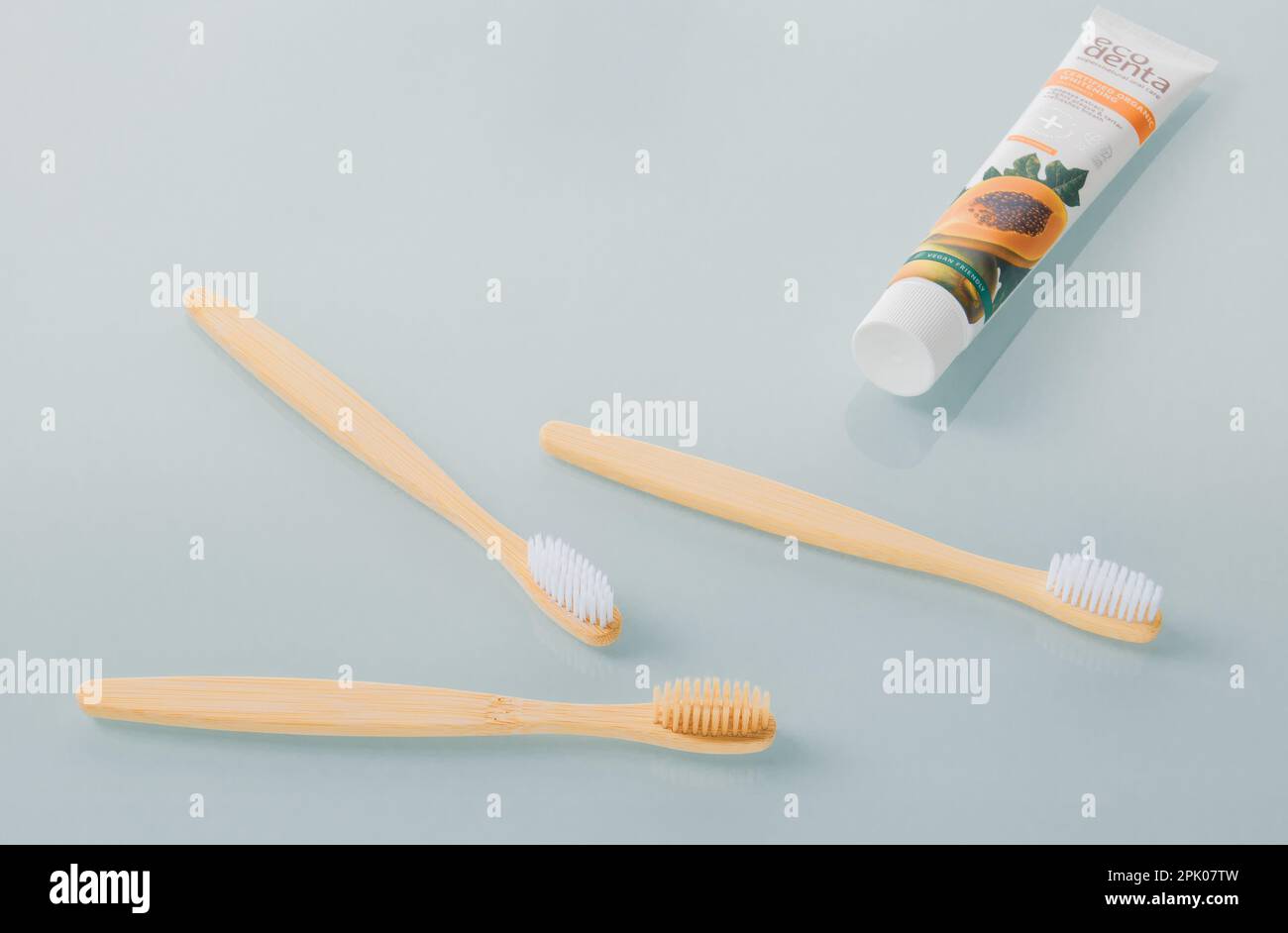 Three eco-friendly bamboo toothbrushes and a tube of eco-friendly ...