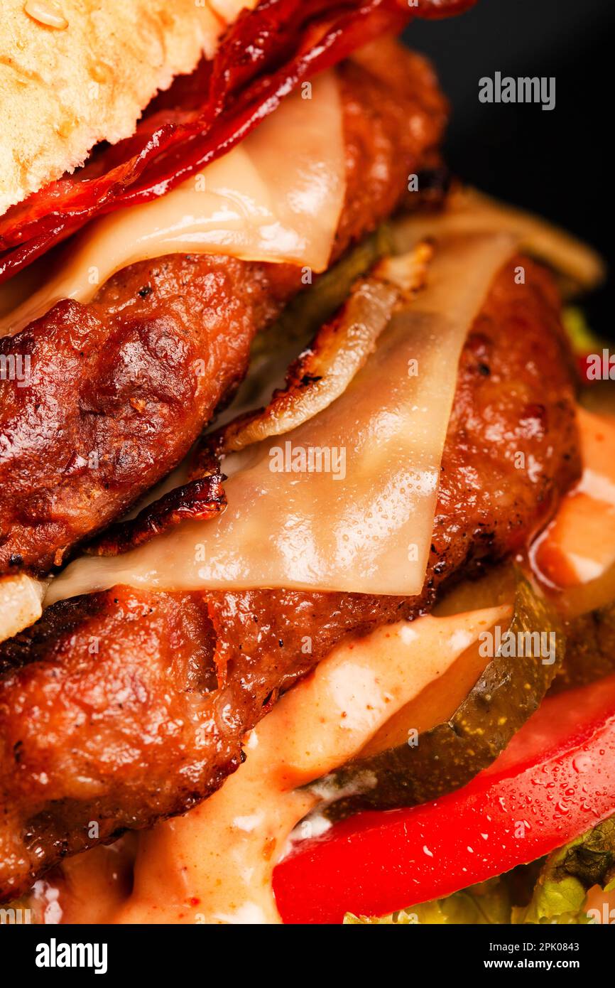 Abstract double burger with bacon cheese onions tomatoes cucumber ...