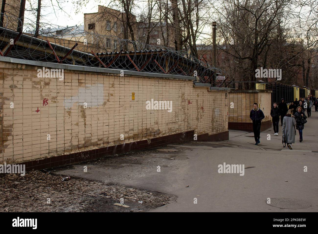 People walk by the walls of the Lefortovo prison reinforced with barbed ...