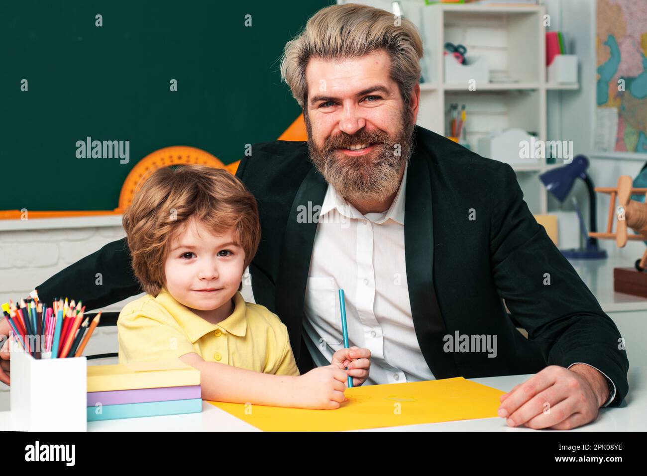 Preschool tutorship. Young happy family father and son schooling math ...