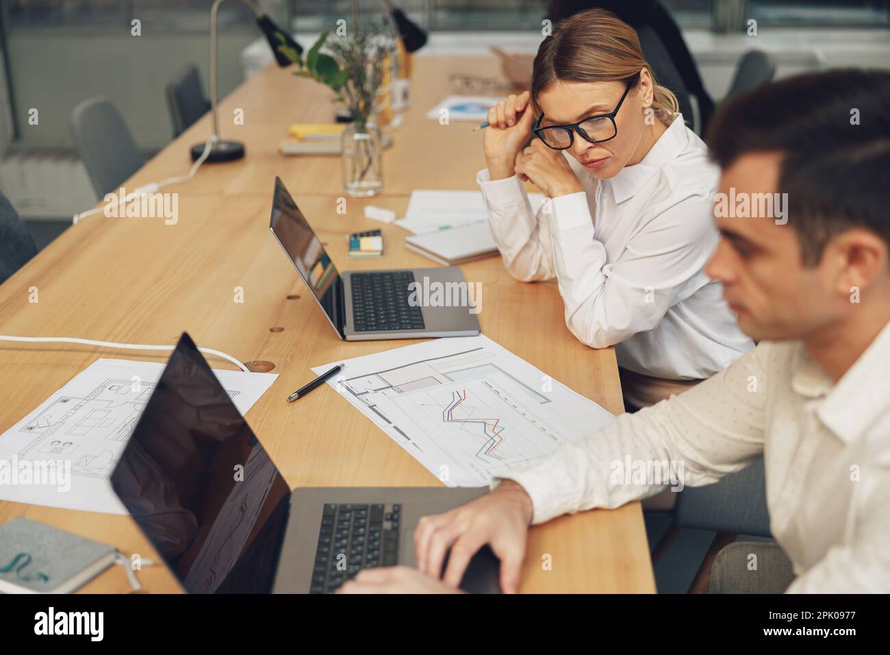 Two colleagues coworkers working together on new business plan during ...