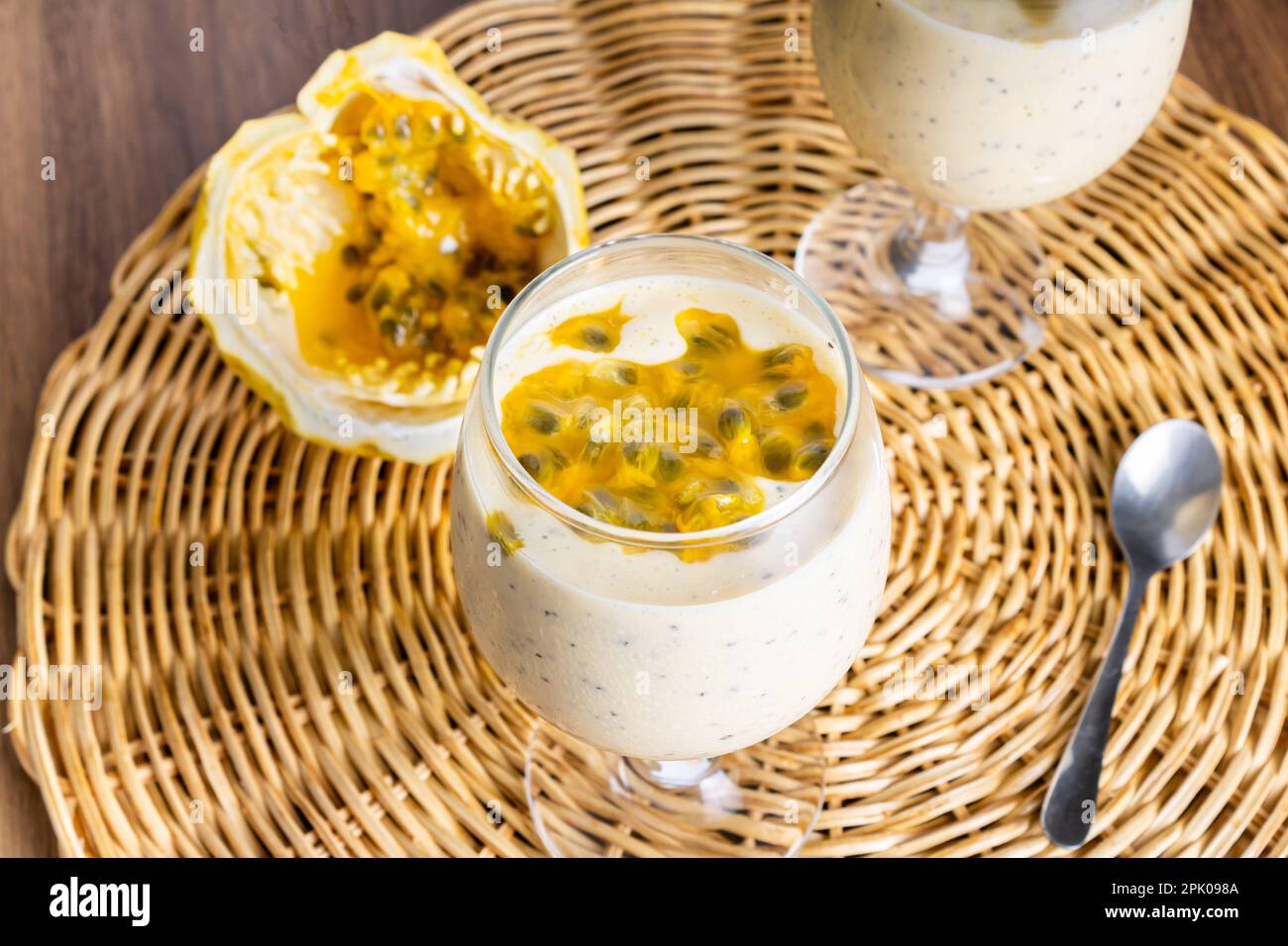 Passion fruit mousse in a glass bowl, with passion fruit in the ...
