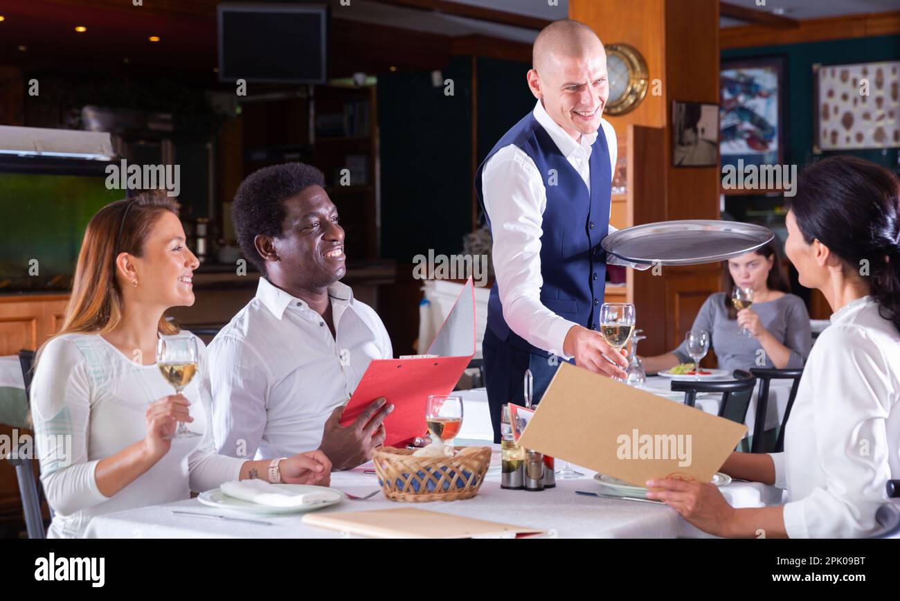 adult male garson to clients in restaurante Stock Photo - Alamy