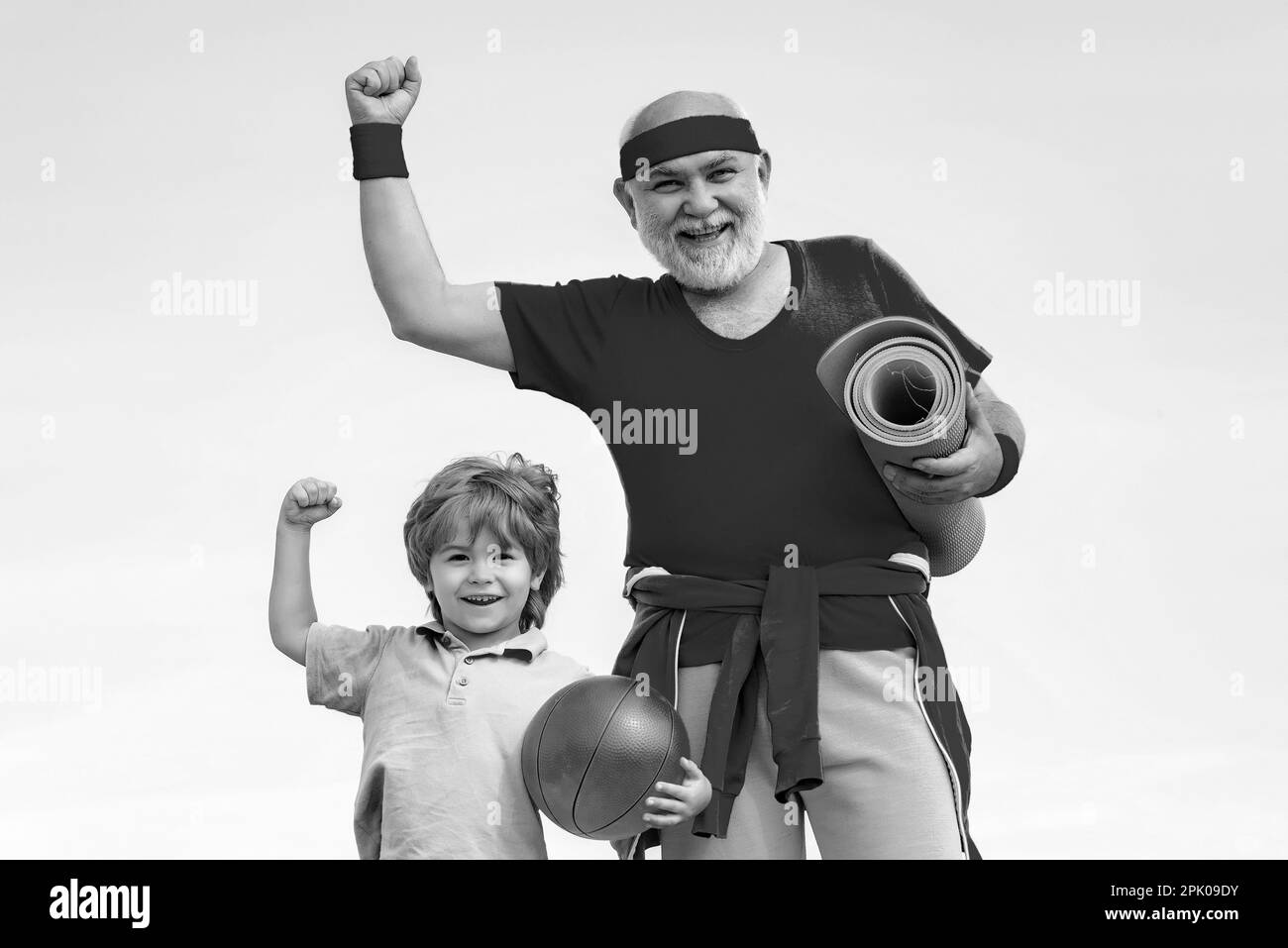 Father and child training together. Grandfather giving grandson ride on ...