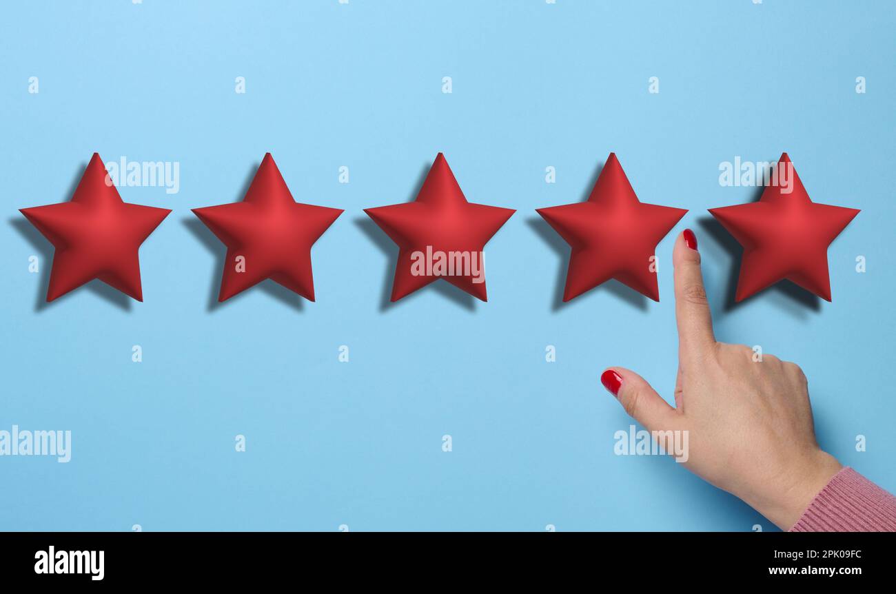 Five red stars and a hand on a blue background. Evaluation of the ...
