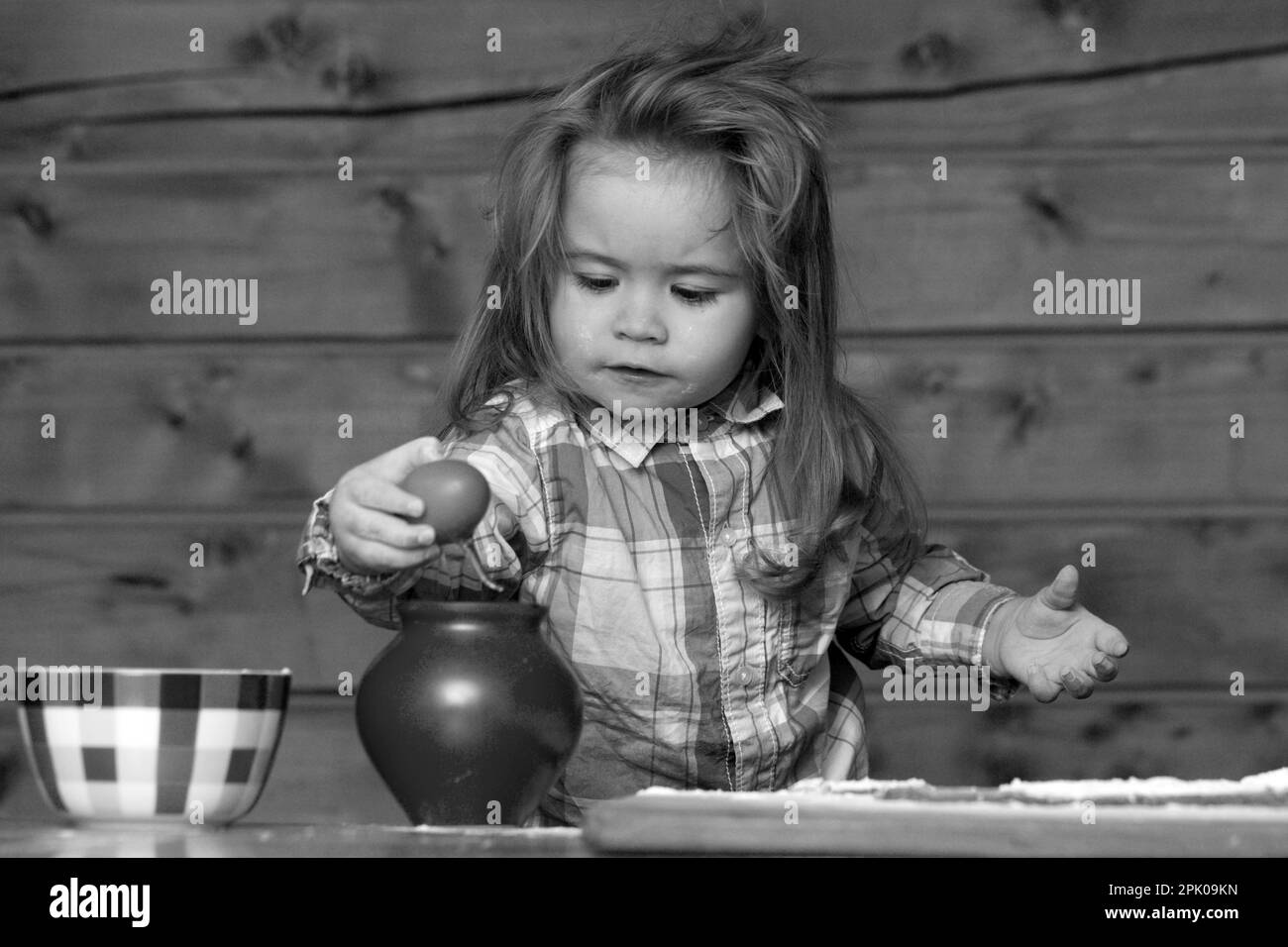 Baby boy in the kitchen cooking, playing with eggs. Baby food, family ... Baby boy in the kitchen cooking, playing with eggs. Baby food, family ...