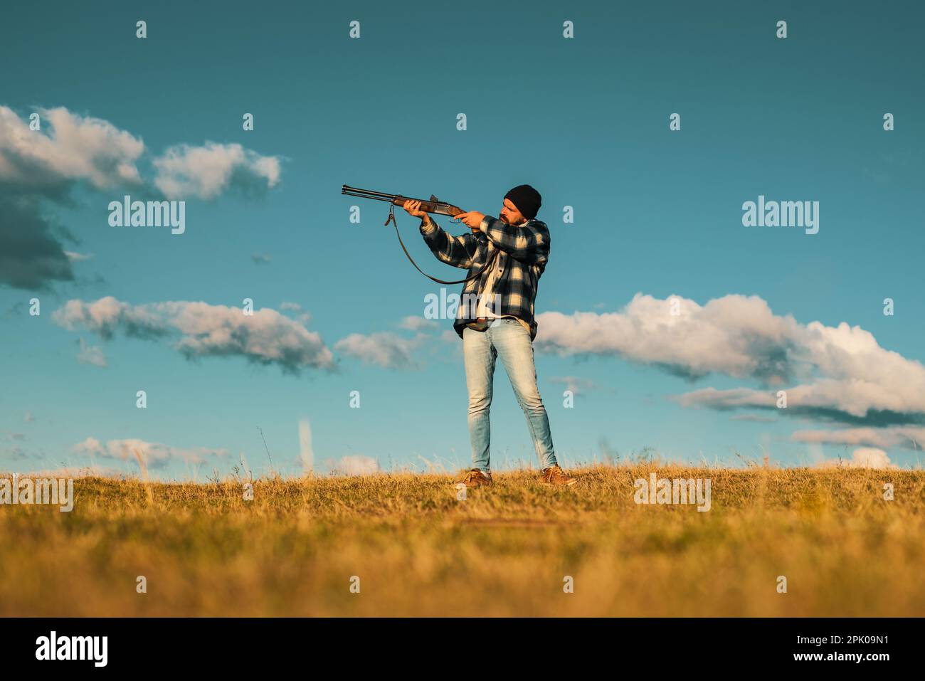 Hunter with Powerful Rifle with Scope Spotting Animals. Hunter in the ...