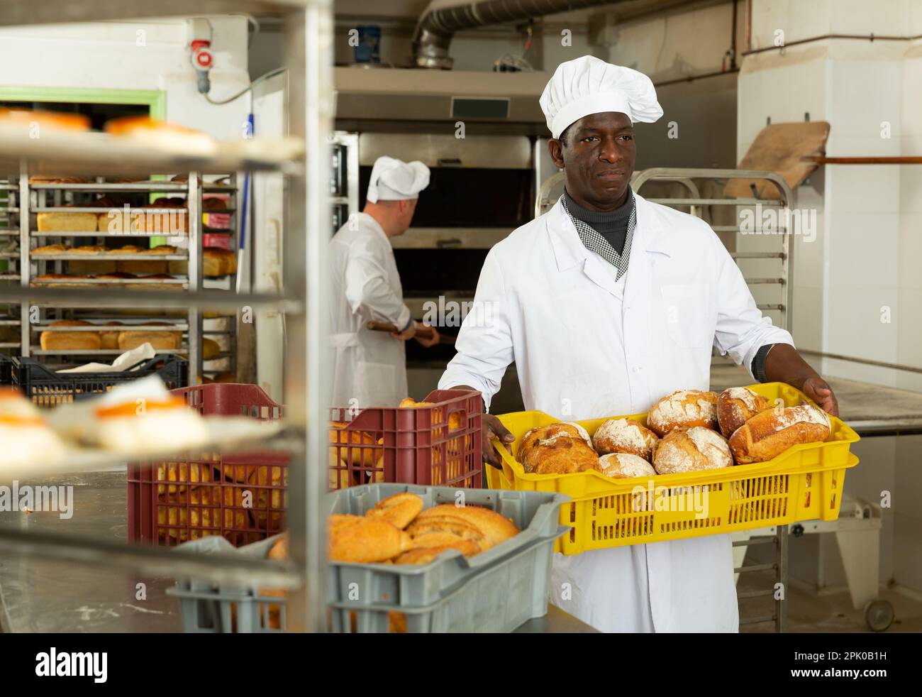 African baker carrying box with baked bread Stock Photo - Alamy