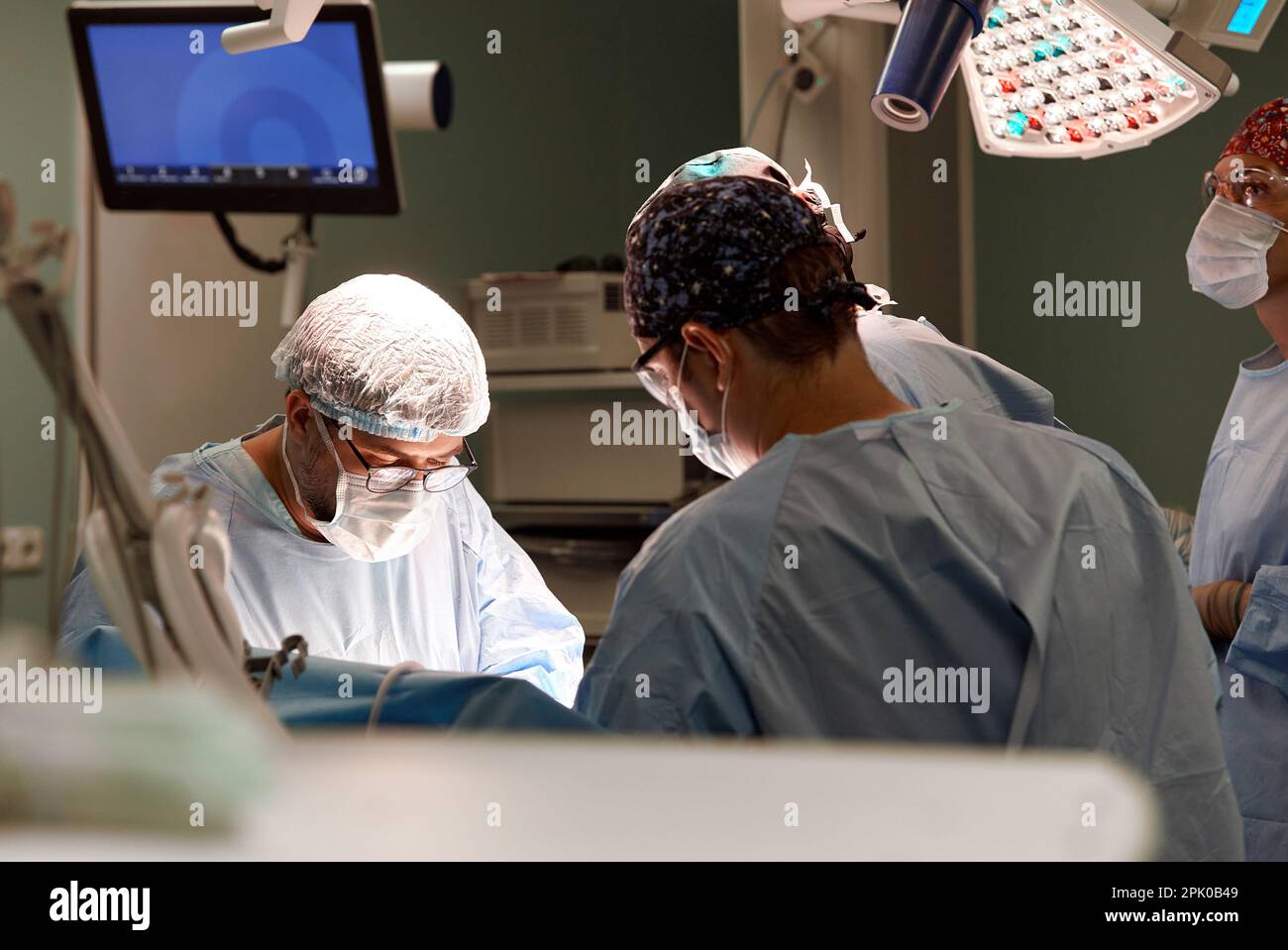 Shot of two experienced surgeons and an alert nurse performing an ...