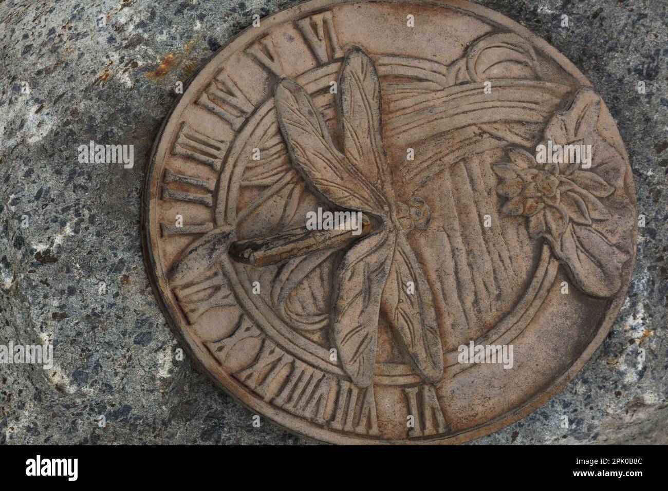 Sundial on granite rock surface in backyard garden in spring Stock ...