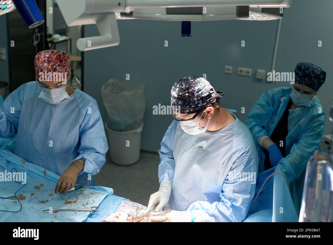 Group of surgeons doing surgery in a modern hospital operating room ...
