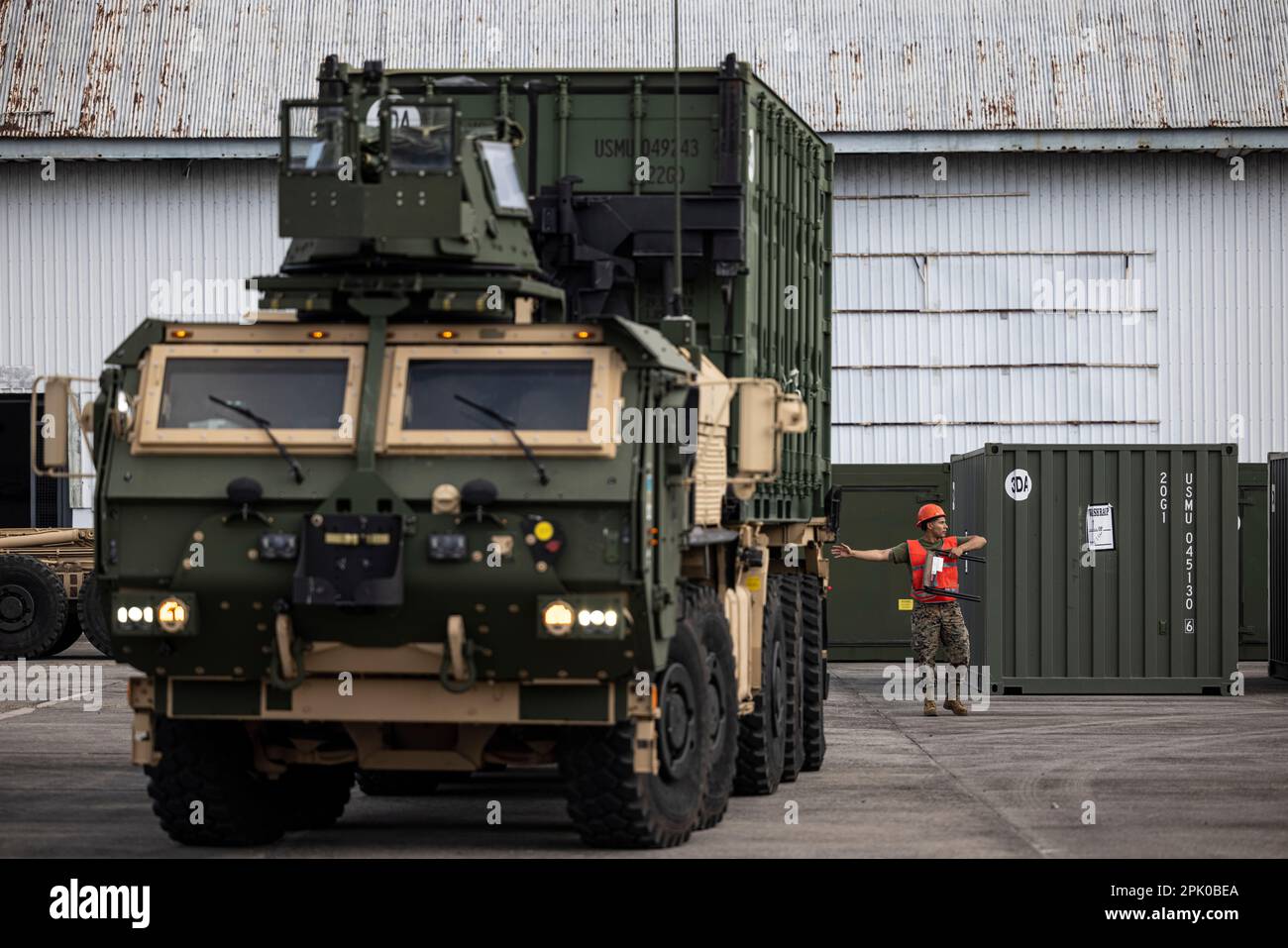 A U.S. Marine with 3rd Landing Support Battalion ground guides a ...