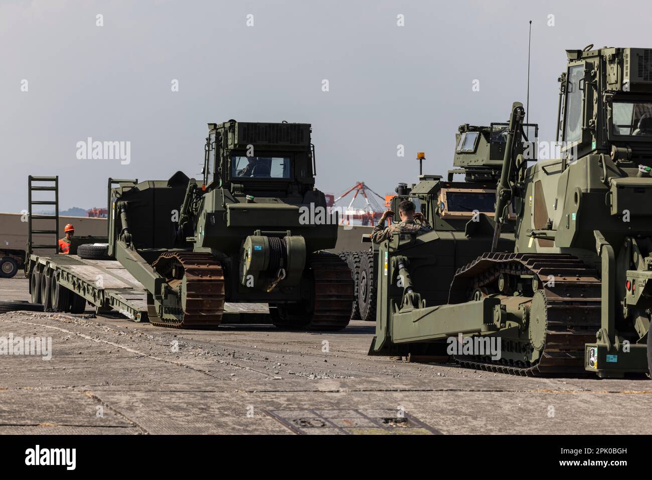 A U.S. Marine with 3rd Landing Support Battalion ground guides an 850JR ...