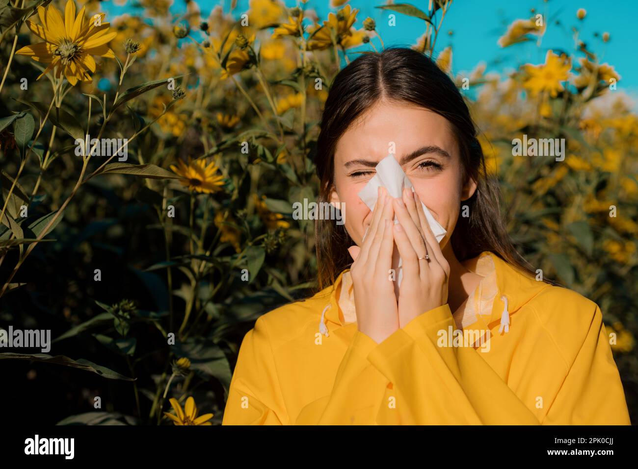 Woman with napkin fighting blossom allergie outdoor. Attractive girl ...