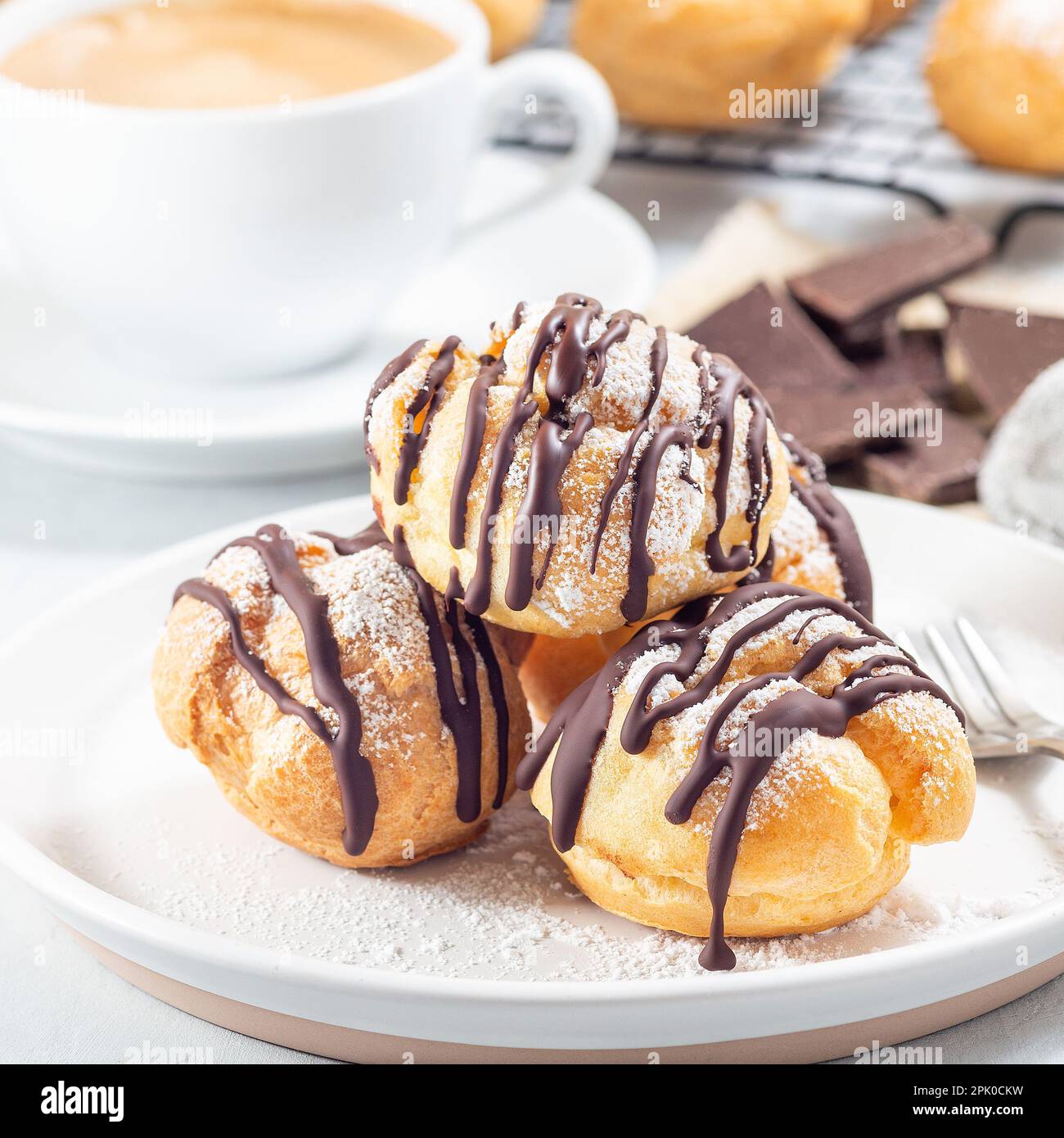 Homemade profiteroles with whipped cream and chocolate filling, covered ...