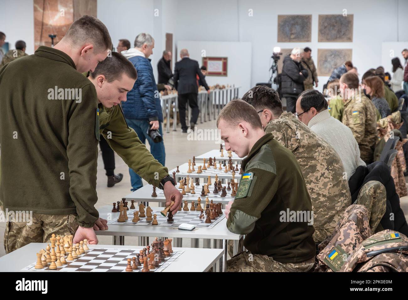Soldiers play chess in a simultaneous chess session in Lviv. Civilians ...