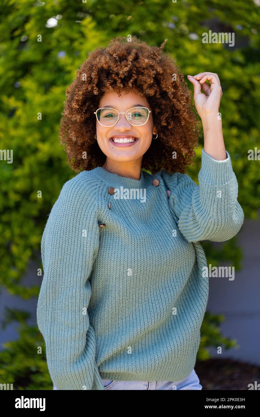Portrait of happy biracial beautiful young woman with afro hair ...