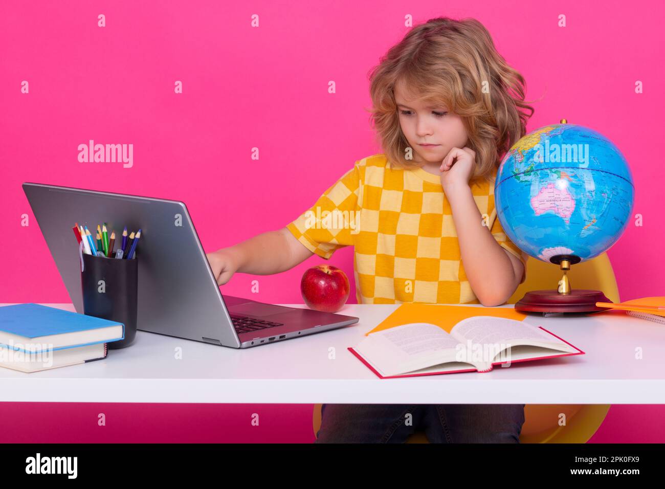 School child using laptop computer. School child 7-8 years old with ...