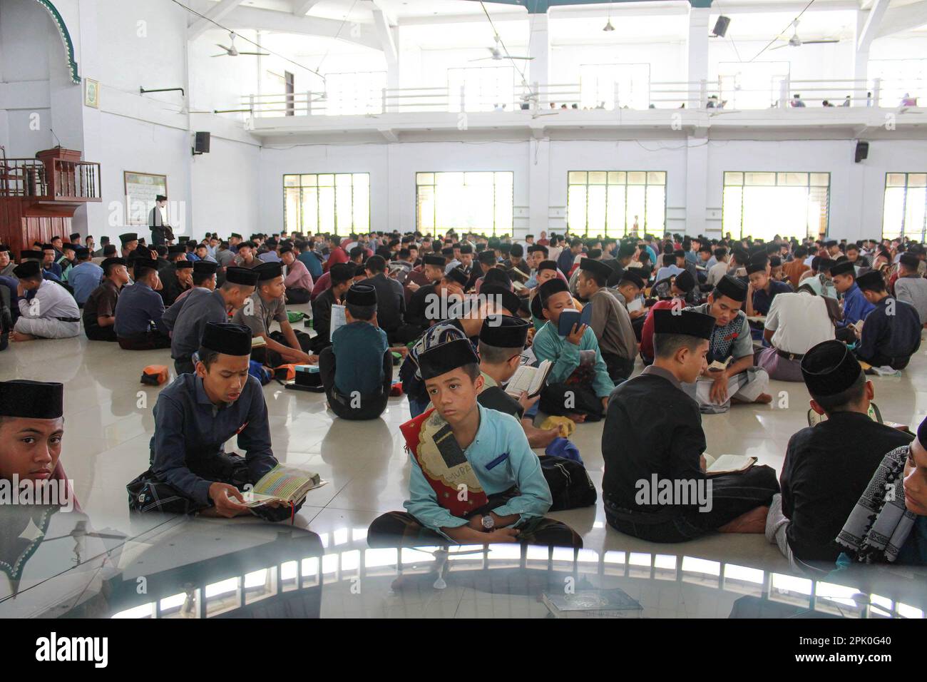 Muslim students sit in circles during a Koran recital class in the holy ...