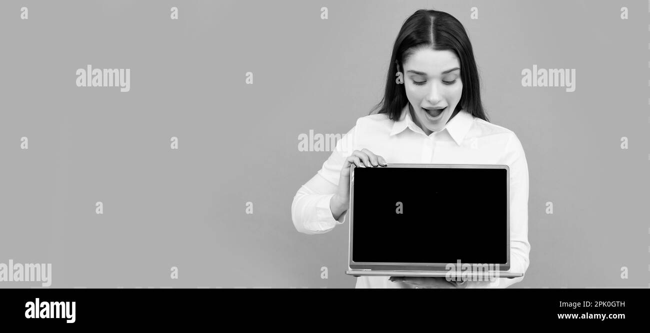 surprised woman in white shirt showing computer ad presentation, copy ...