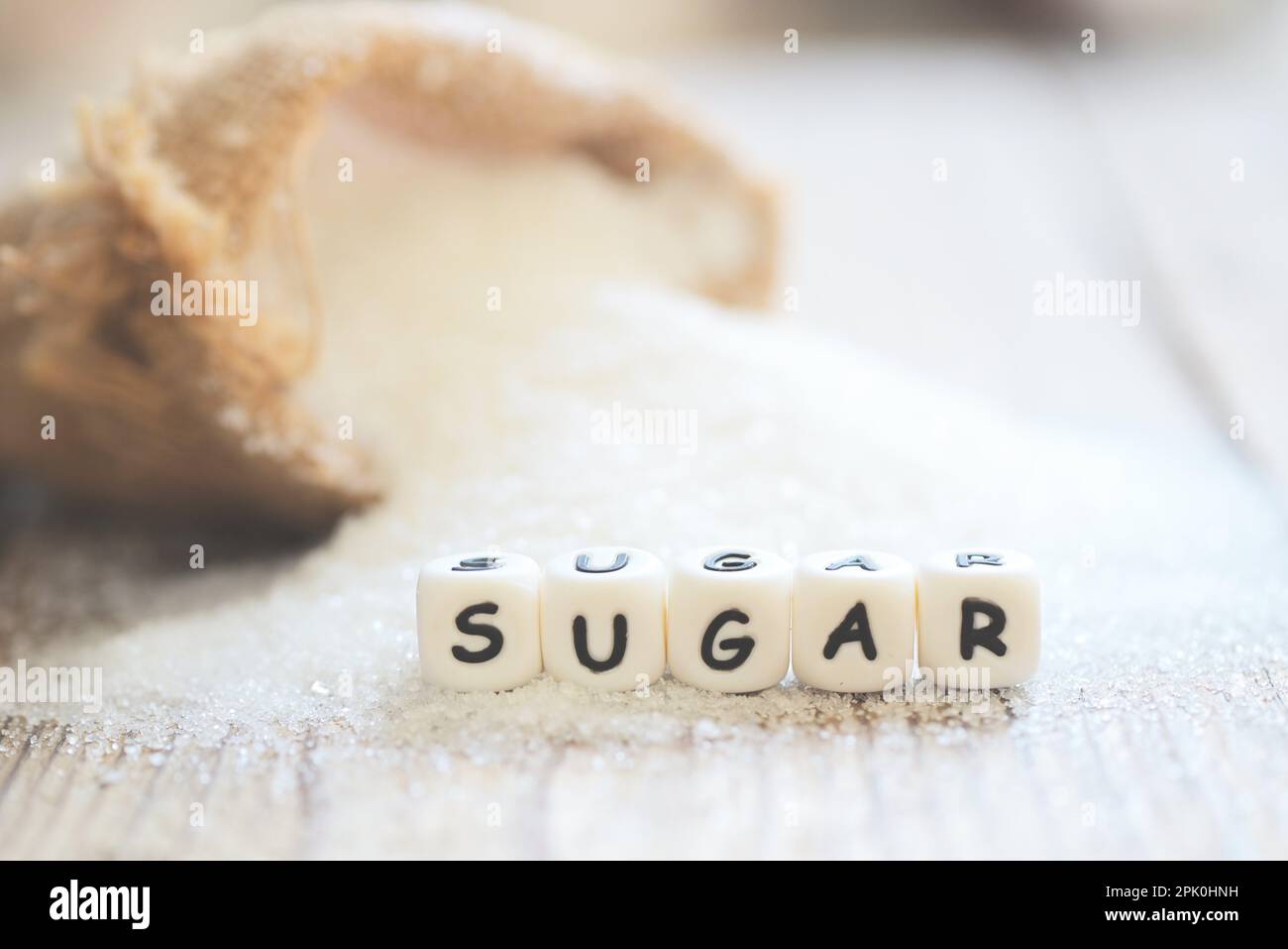 Sugar on sack and wooden background, white sugar for food and sweets ...