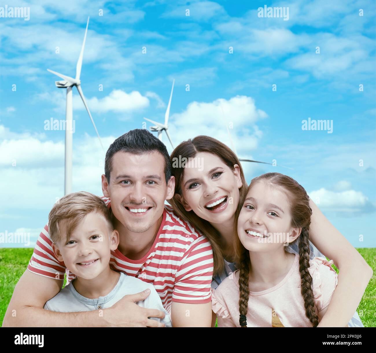 Happy family with children and view of wind energy turbines Stock Photo ...