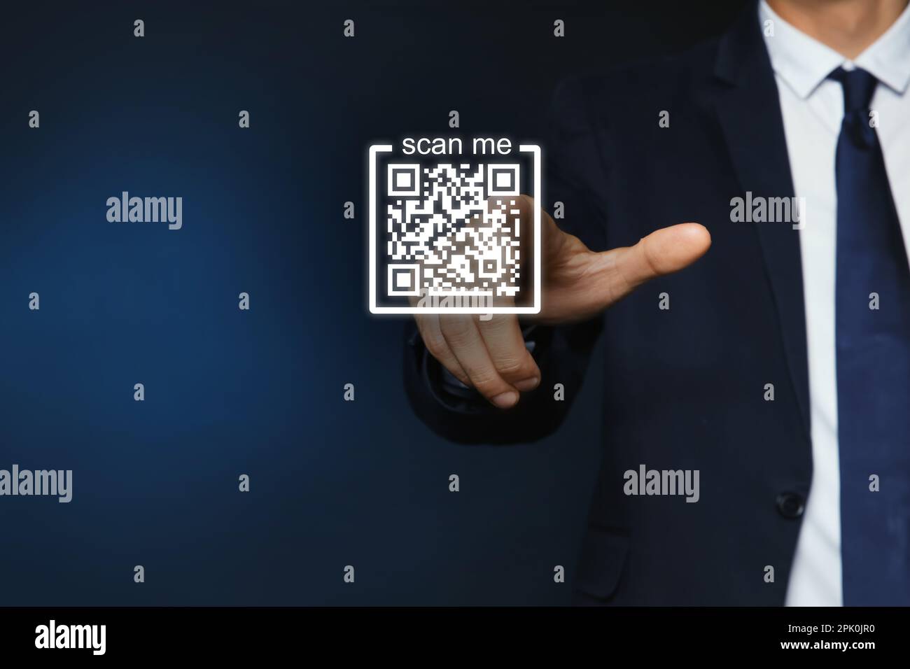 Man pointing at illustration of QR code on dark blue background ...