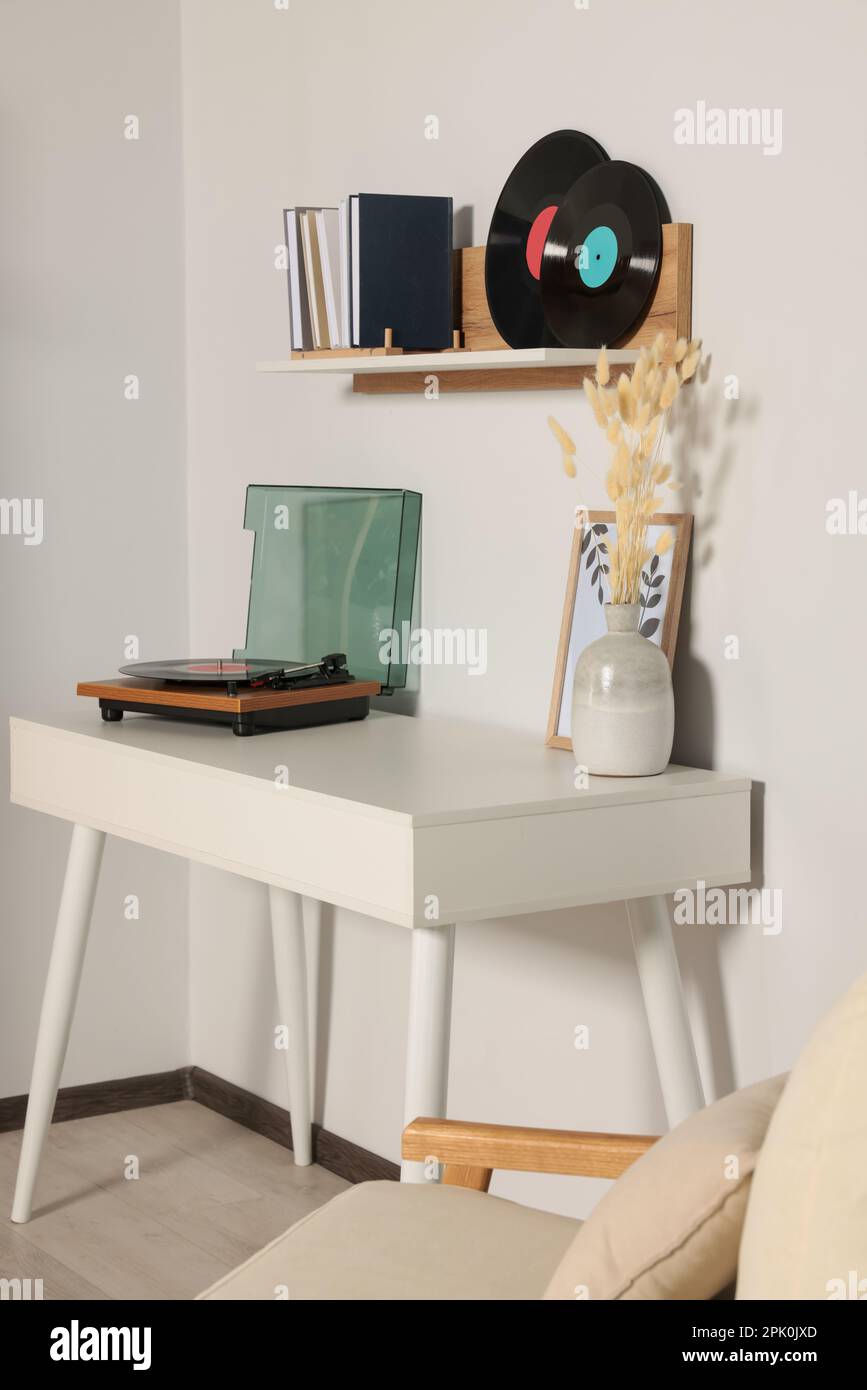 Room interior with stylish turntable on white table and vinyl records ...