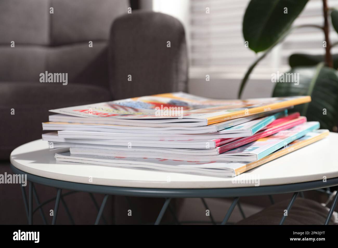 Many stacked magazines on table in room Stock Photo - Alamy